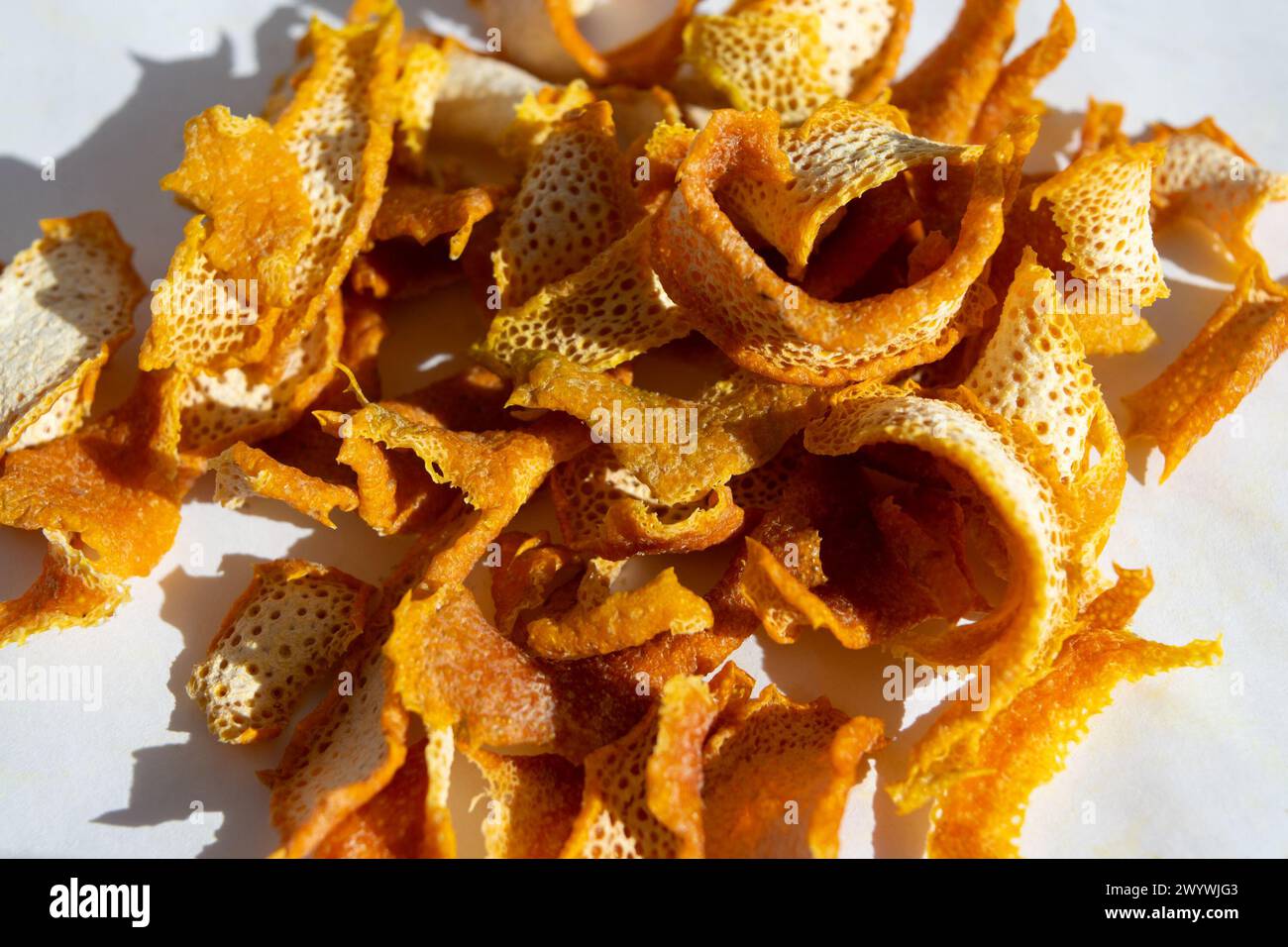 Dried pieces of orange zest, close-up. Additive to tea, for cooking ...