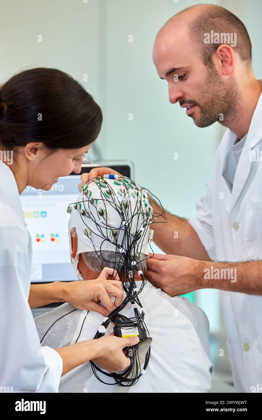 Investigator and patient with assistive robot for upper limb ...