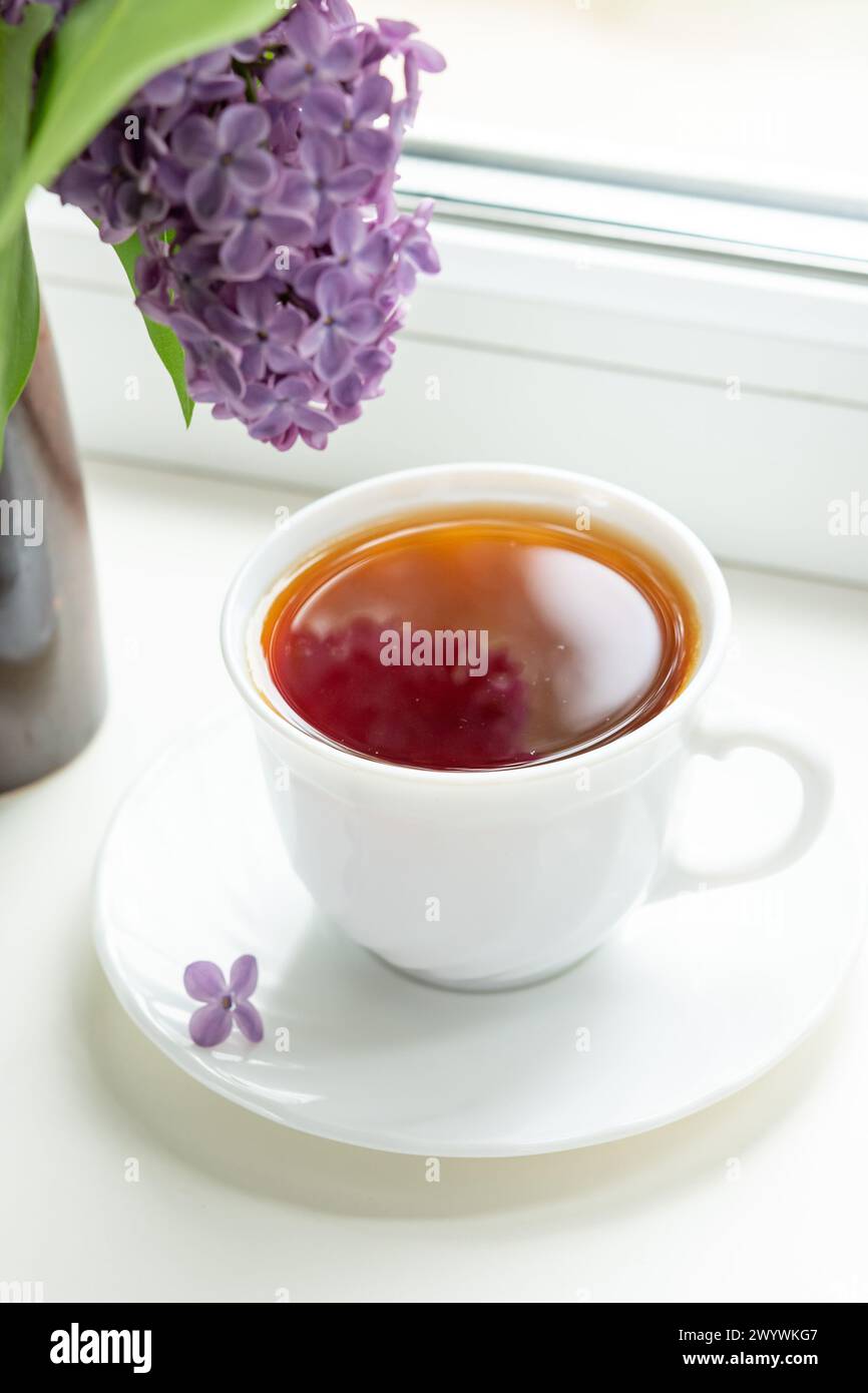 Home interior with a bouquet of blooming lilac flowers on the window ...