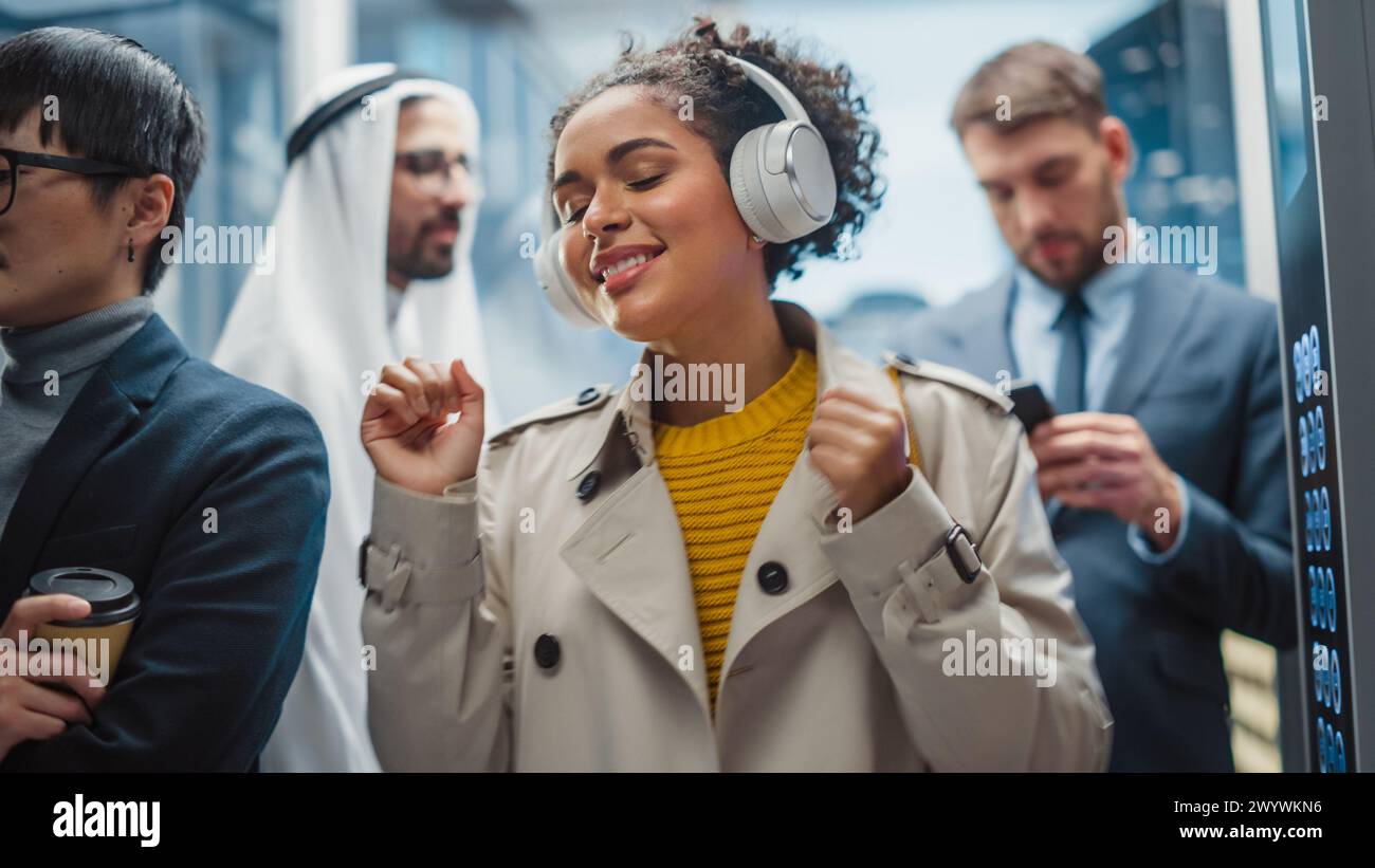 Carefree Black Female Riding Glass Elevator to Office in Modern ...