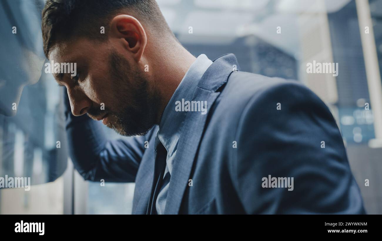 Stressed Out Manager Going Down from Office in a Glass Elevator in ...