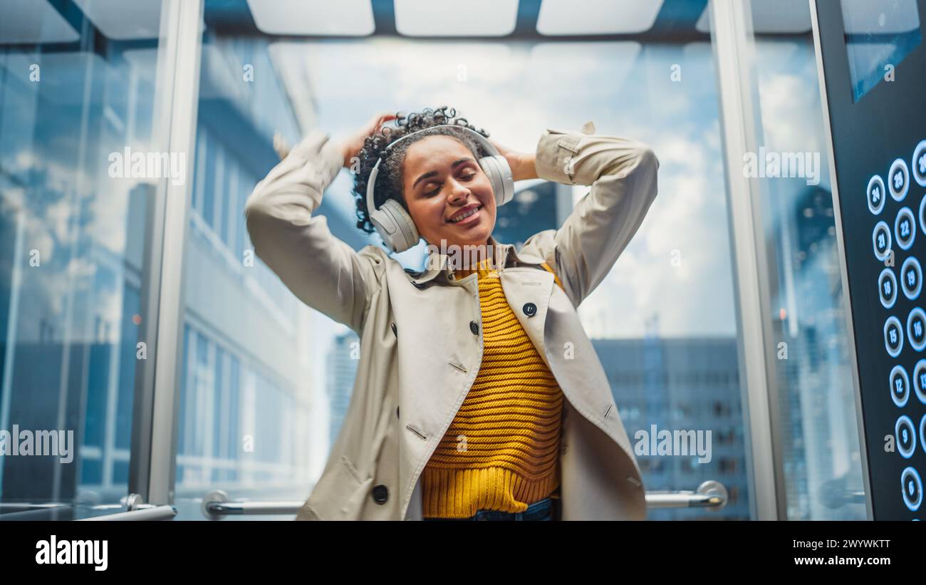 Carefree African American Female Riding Glass Elevator to Office in ...