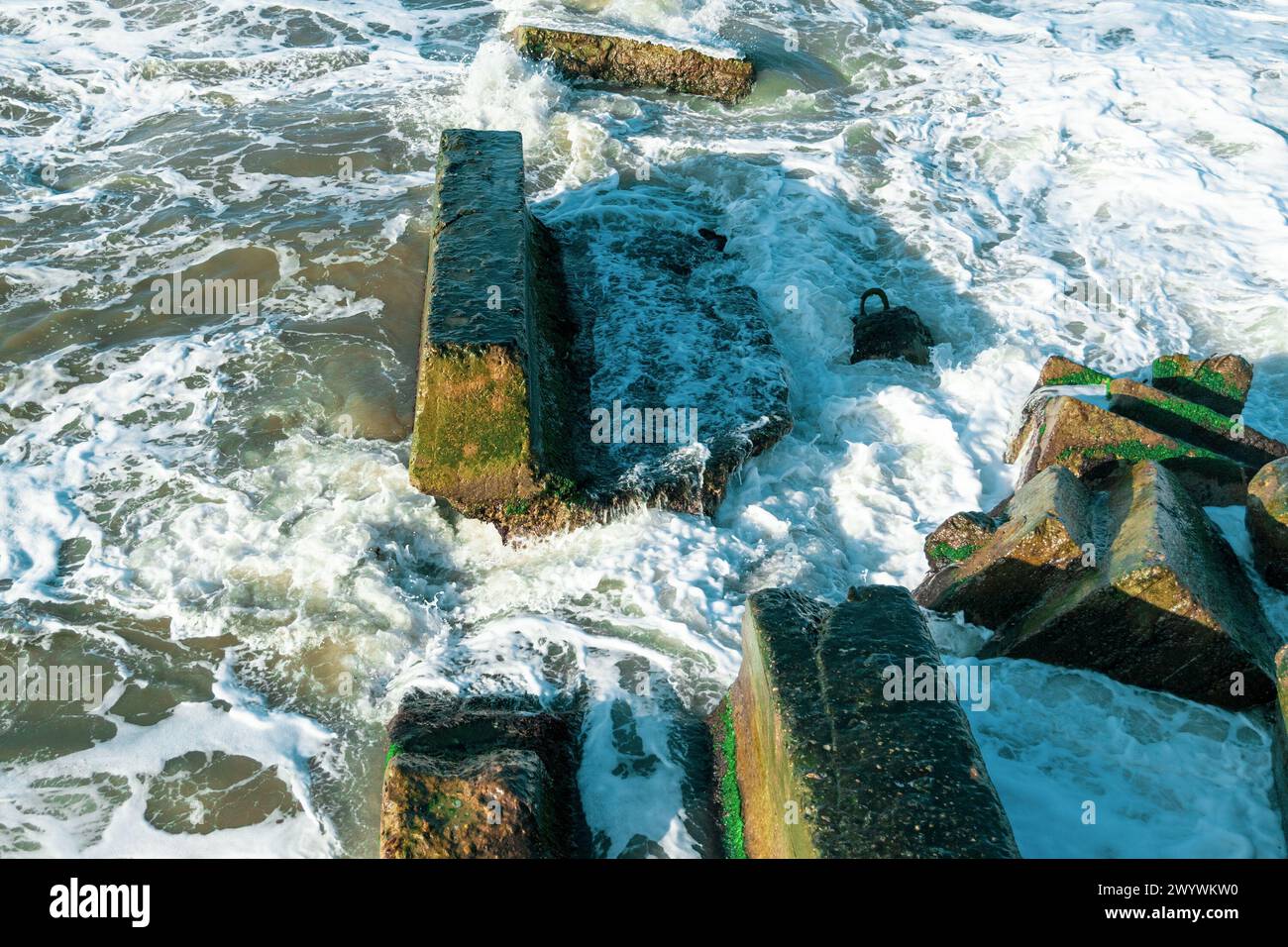 Waves crash on breakwaters. Splashes of water, drops, splash. Marine ...