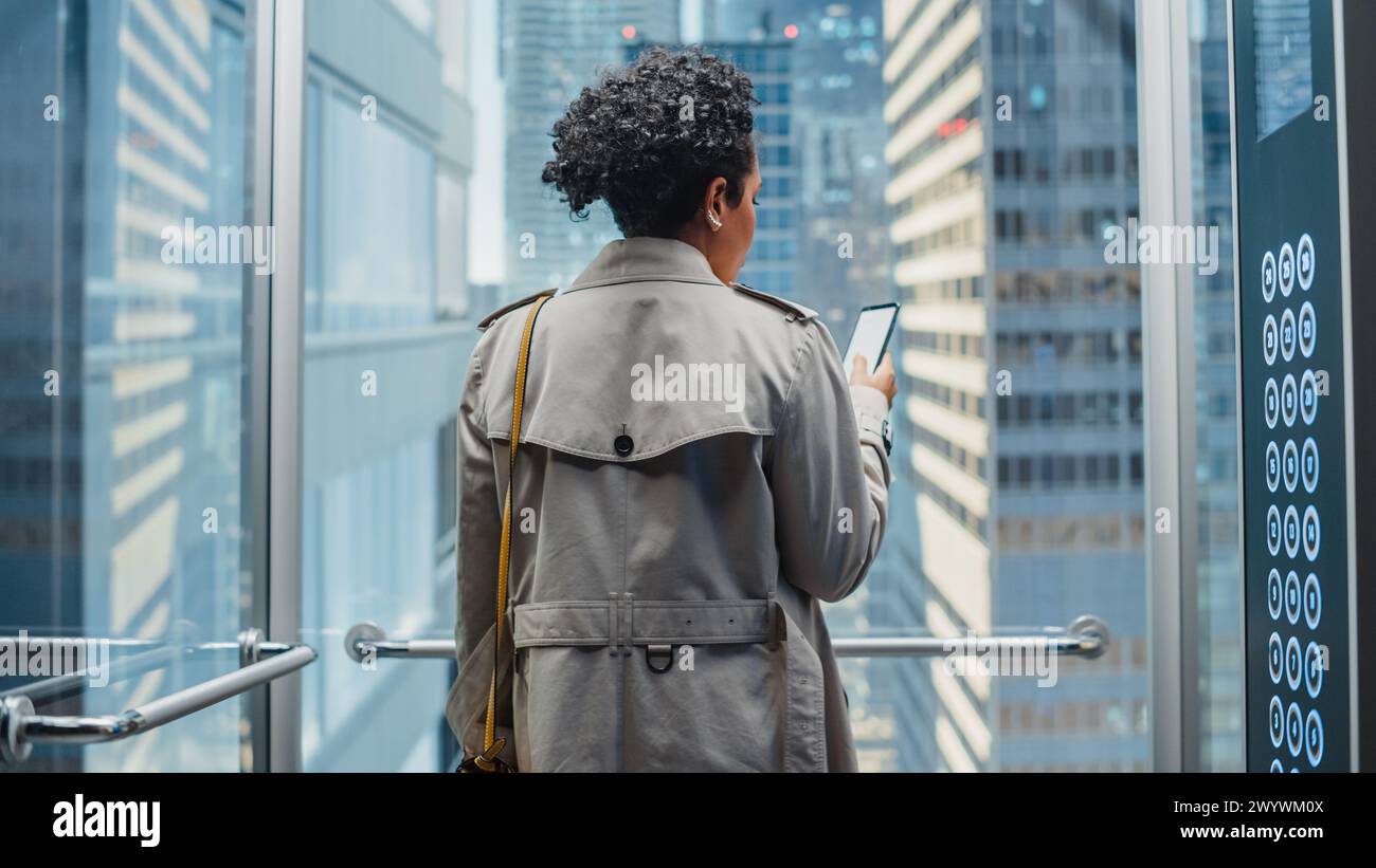 Latin female riding elevator using hi-res stock photography and images ...
