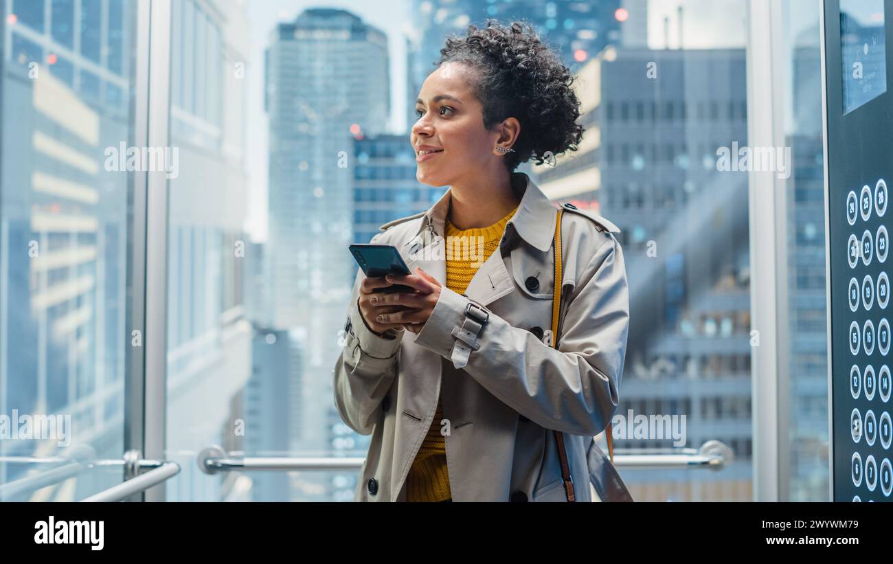 Latin female riding elevator using hi-res stock photography and images ...