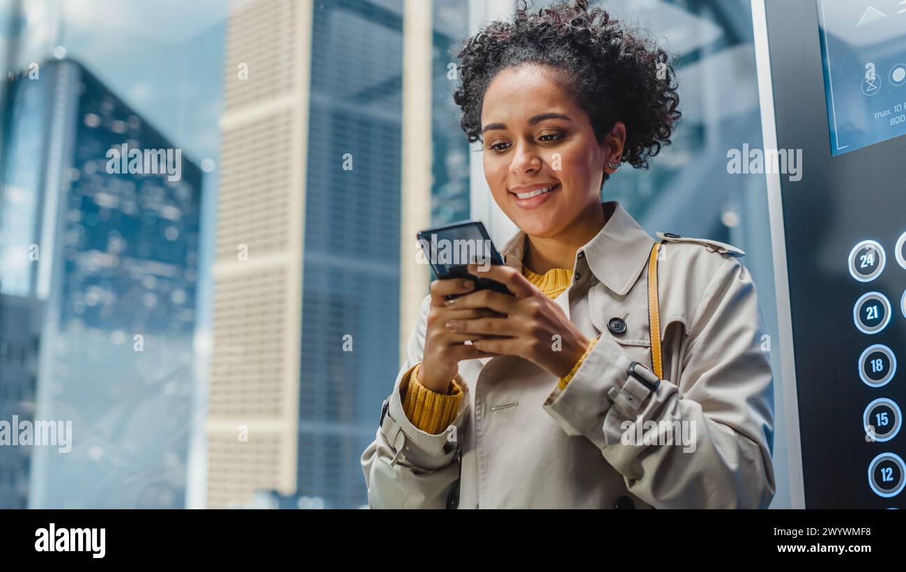 Latin female riding elevator using hi-res stock photography and images ...
