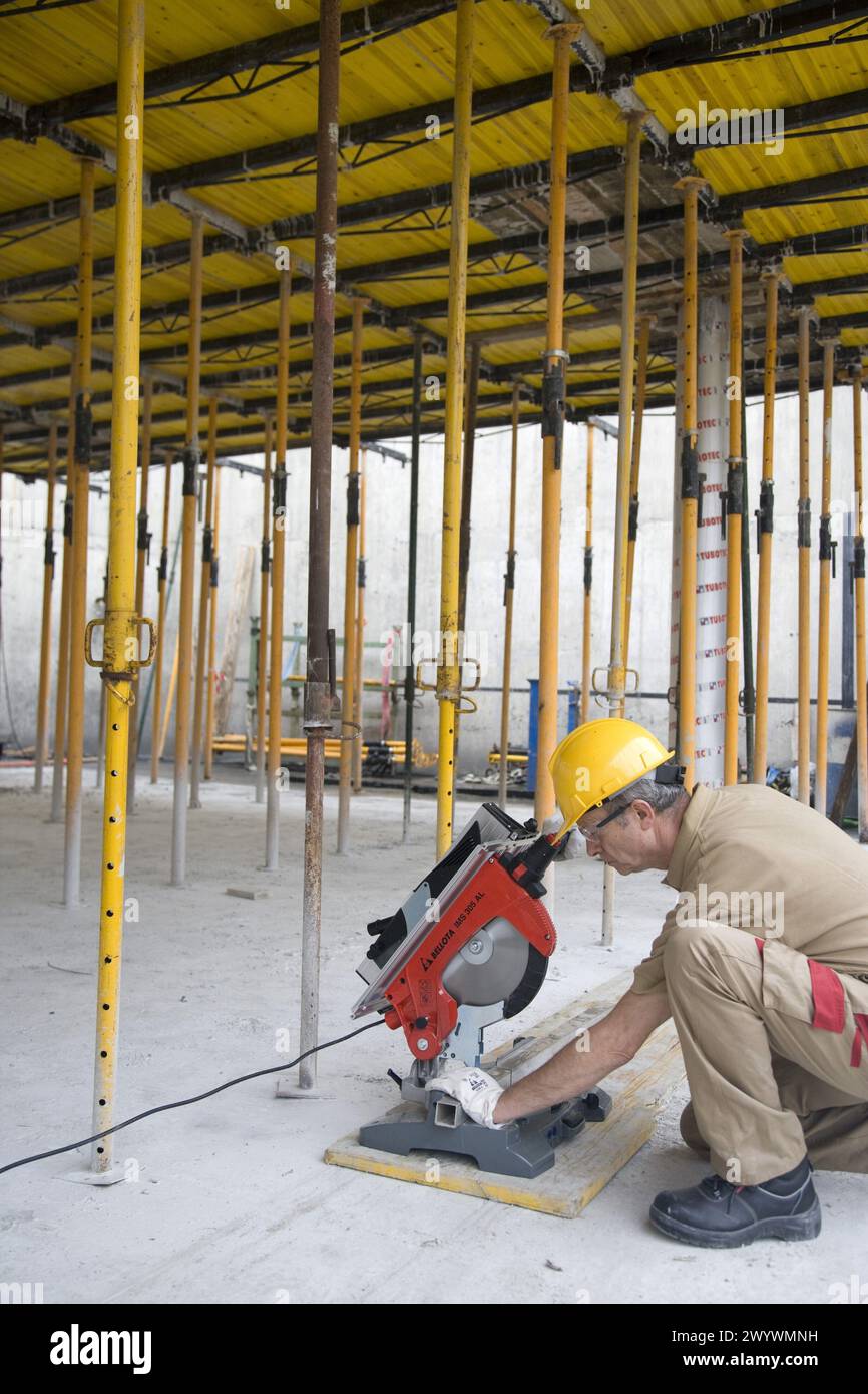 Construction worker cutting aluminum with electric cutter Stock Photo ...
