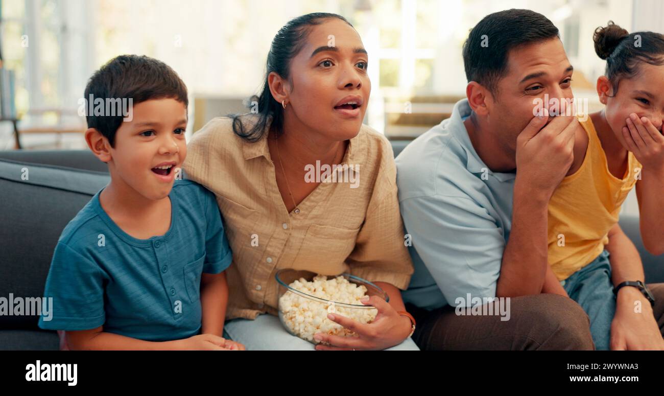 Shock, TV and excited family on sofa with popcorn for bonding, quality ...