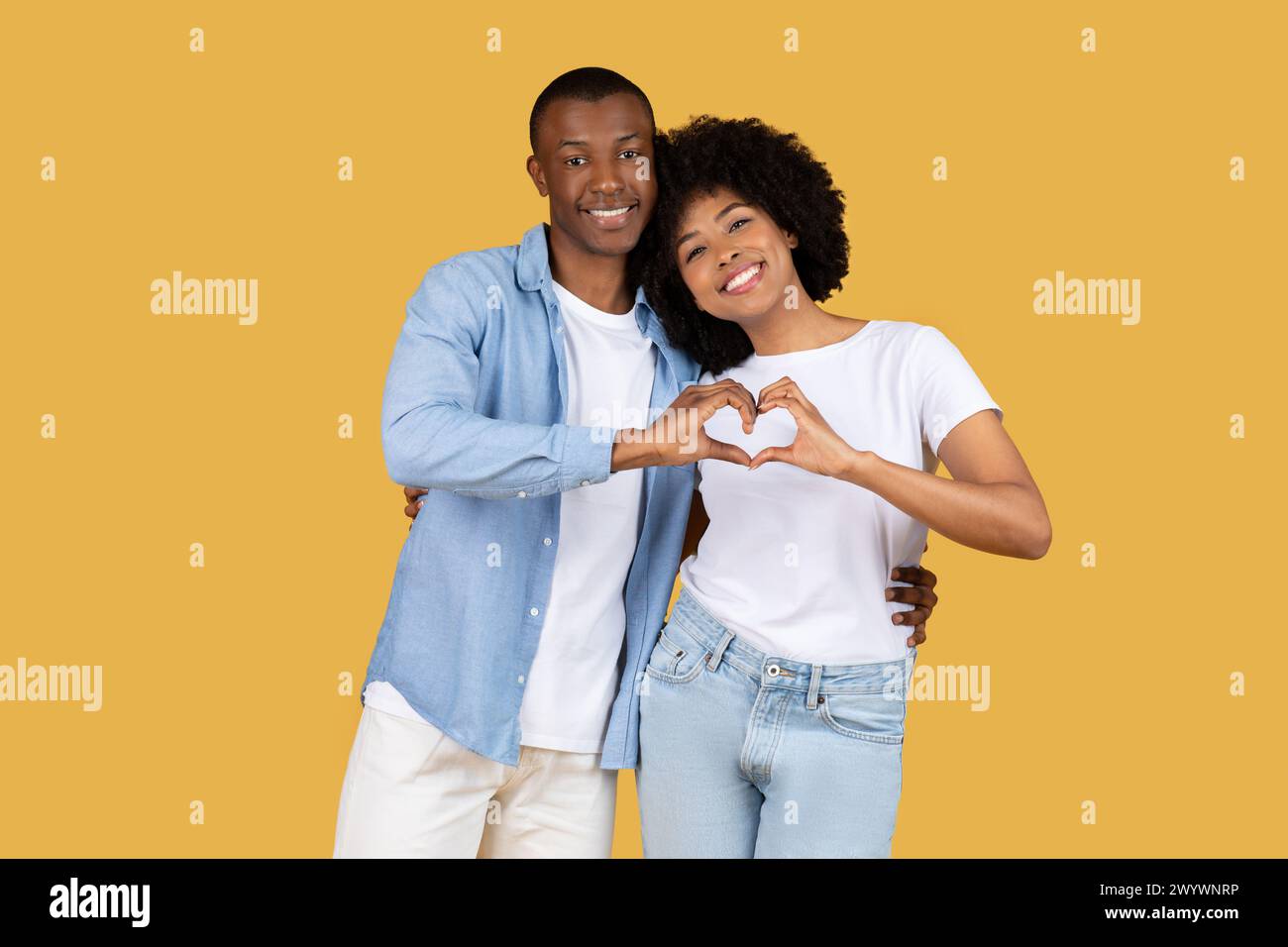 Couple forming a heart shape with hands Stock Photo - Alamy