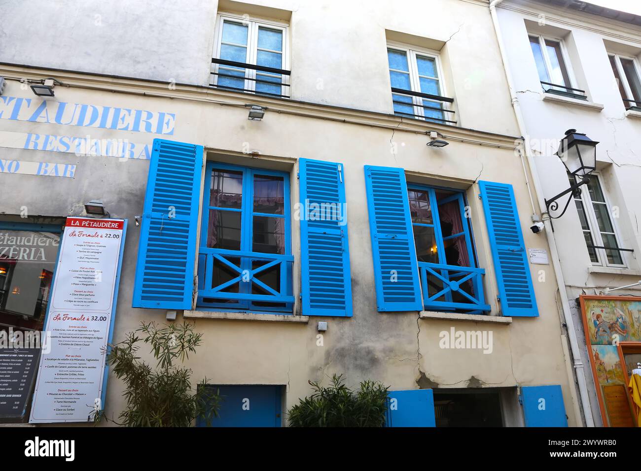 Paris, France -March 31, 2024: View of a typical Parisian cafe, windows ...