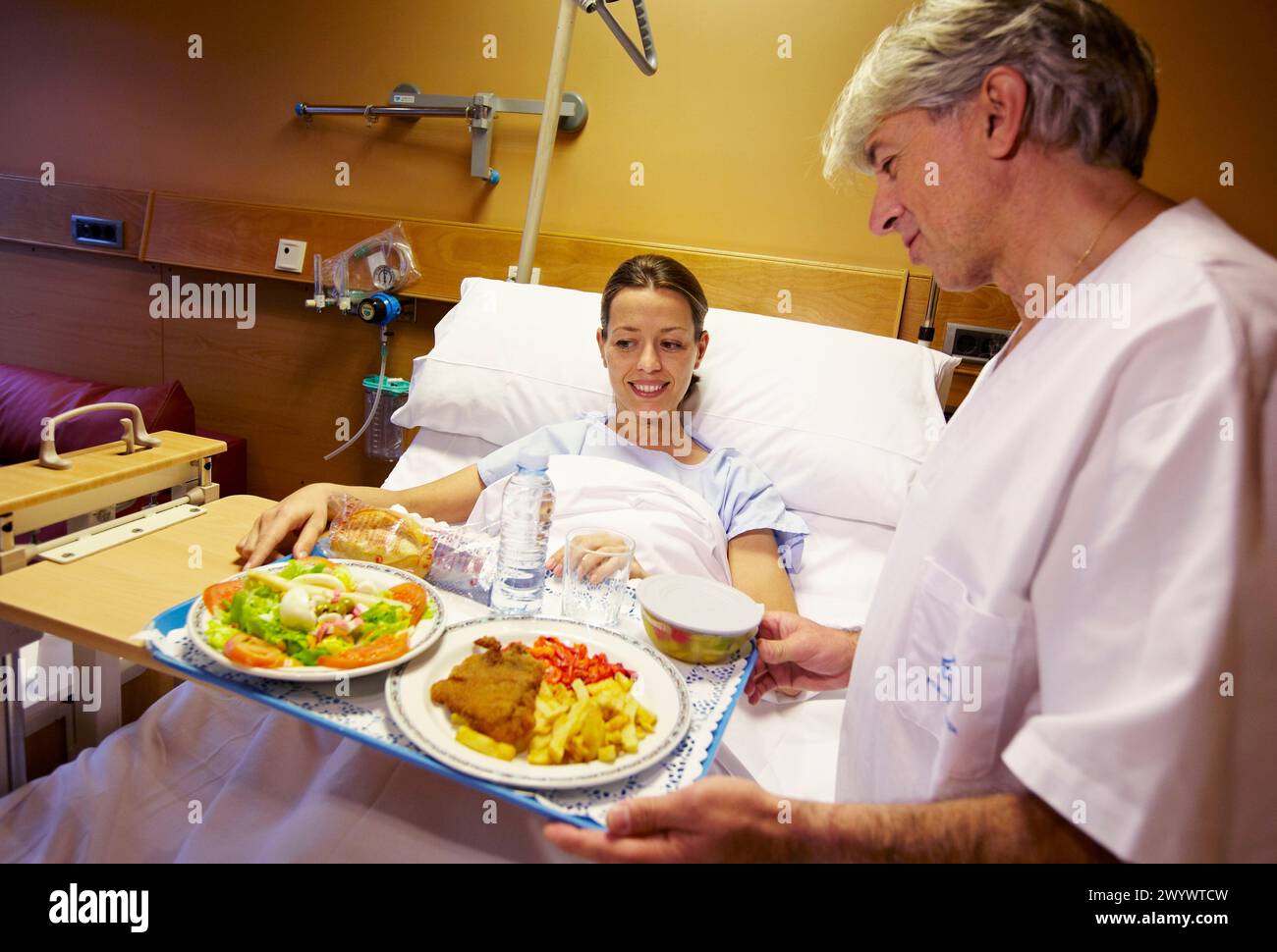 Nurse with food tray and patient in a hospital room. Hospital ...