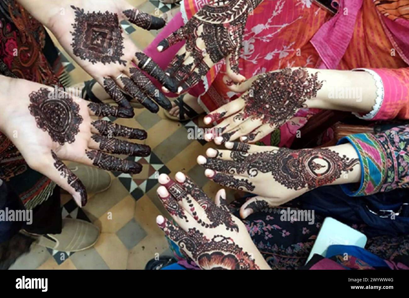 Girls making designs on their hands by (Hina) Mehndi which is ...