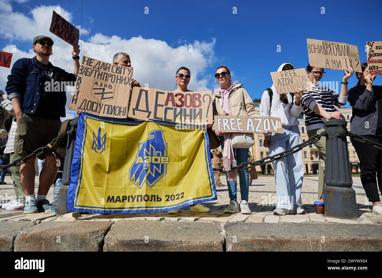 Ukrainian patriots posing with banners "Free Azov" and flag of Azov ...