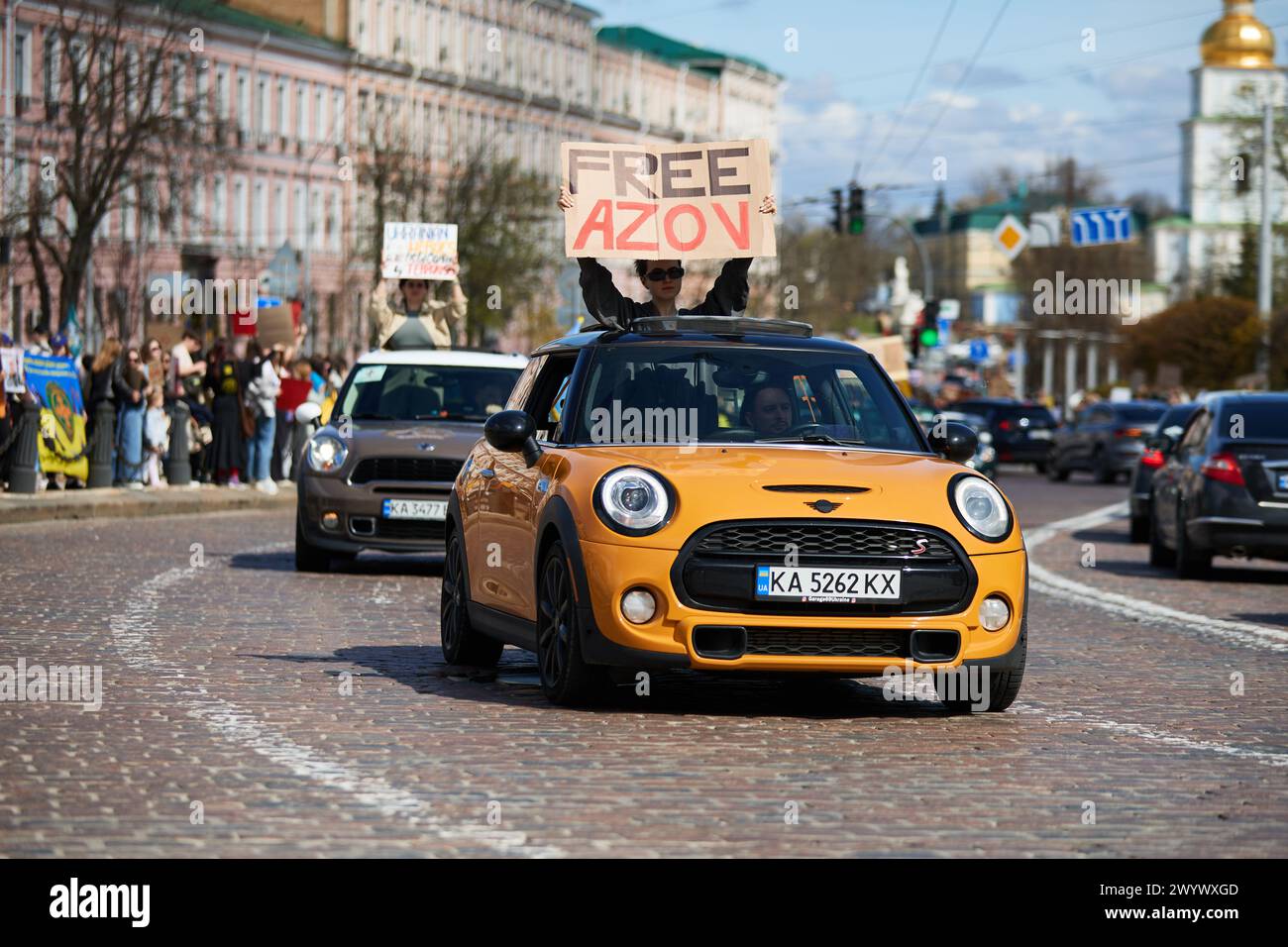 Ukrainian activists driving with banners "Free Azov" on a public ...
