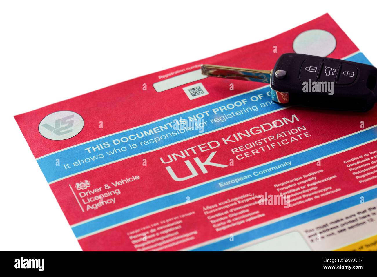 V5C car log book with electronic key fob. Isolated on a white ...