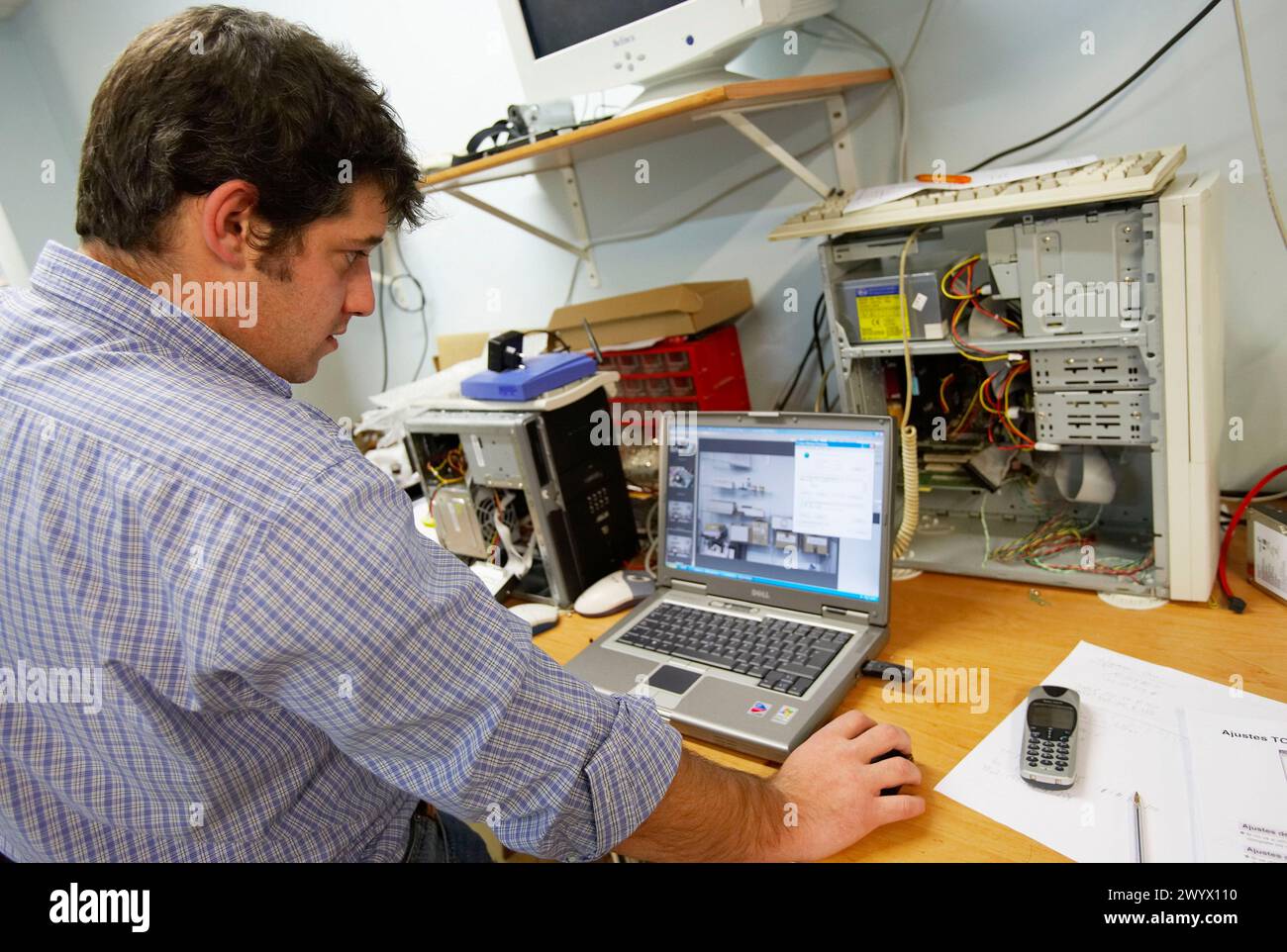 Technician fixing laptop computer at computer store Stock Photo - Alamy