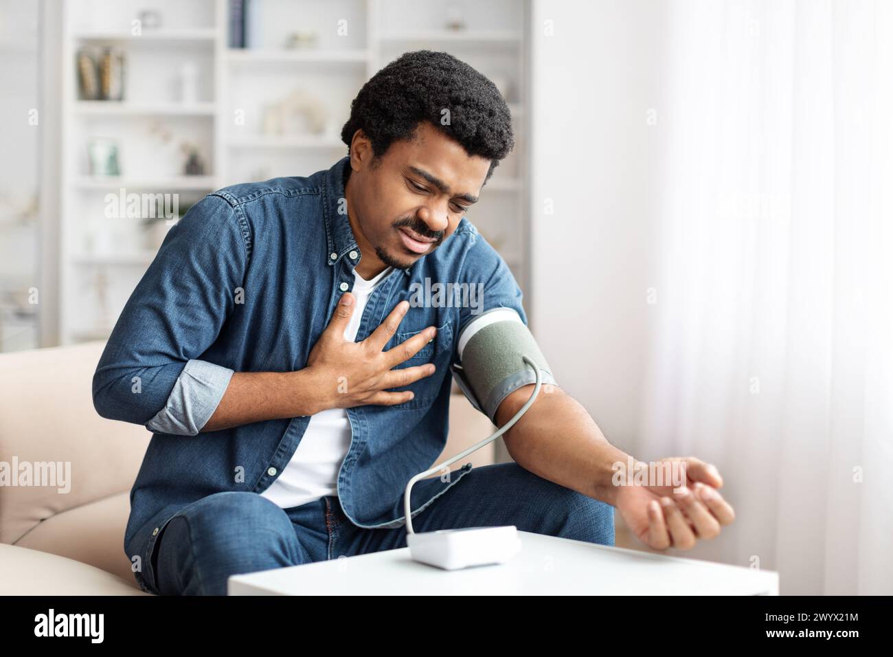 Black Man Experiencing Chest Pain While Monitoring Blood Pressure at ...