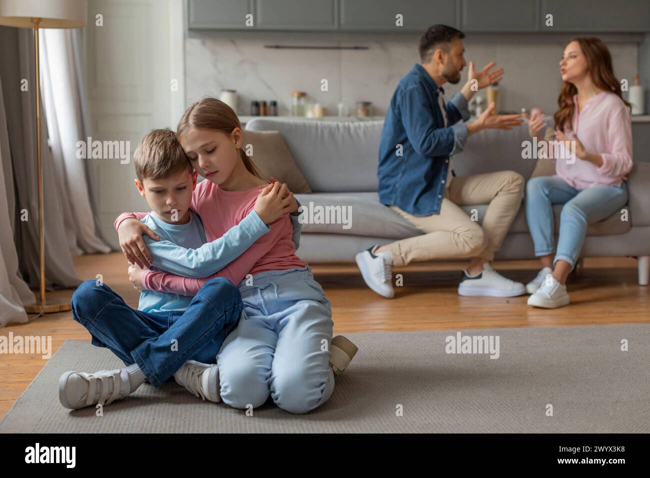 Siblings comforting each other while parents fighting Stock Photo - Alamy