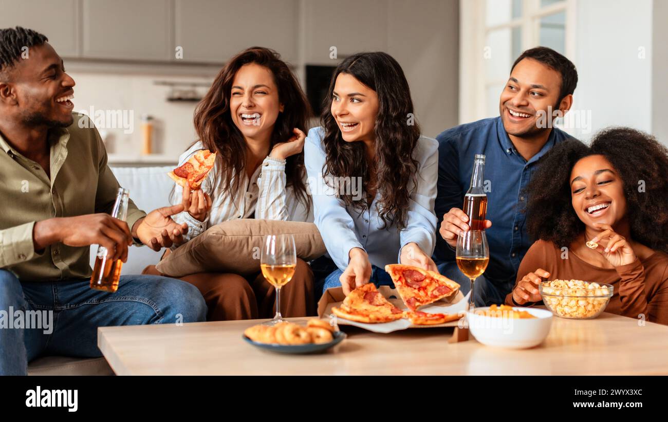 Friends laughing and sharing drinks at home Stock Photo - Alamy