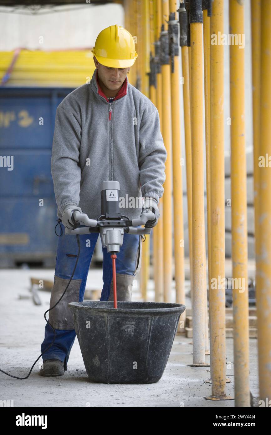 Bricklayer by mass of cement with electric mixer hi-res stock ...
