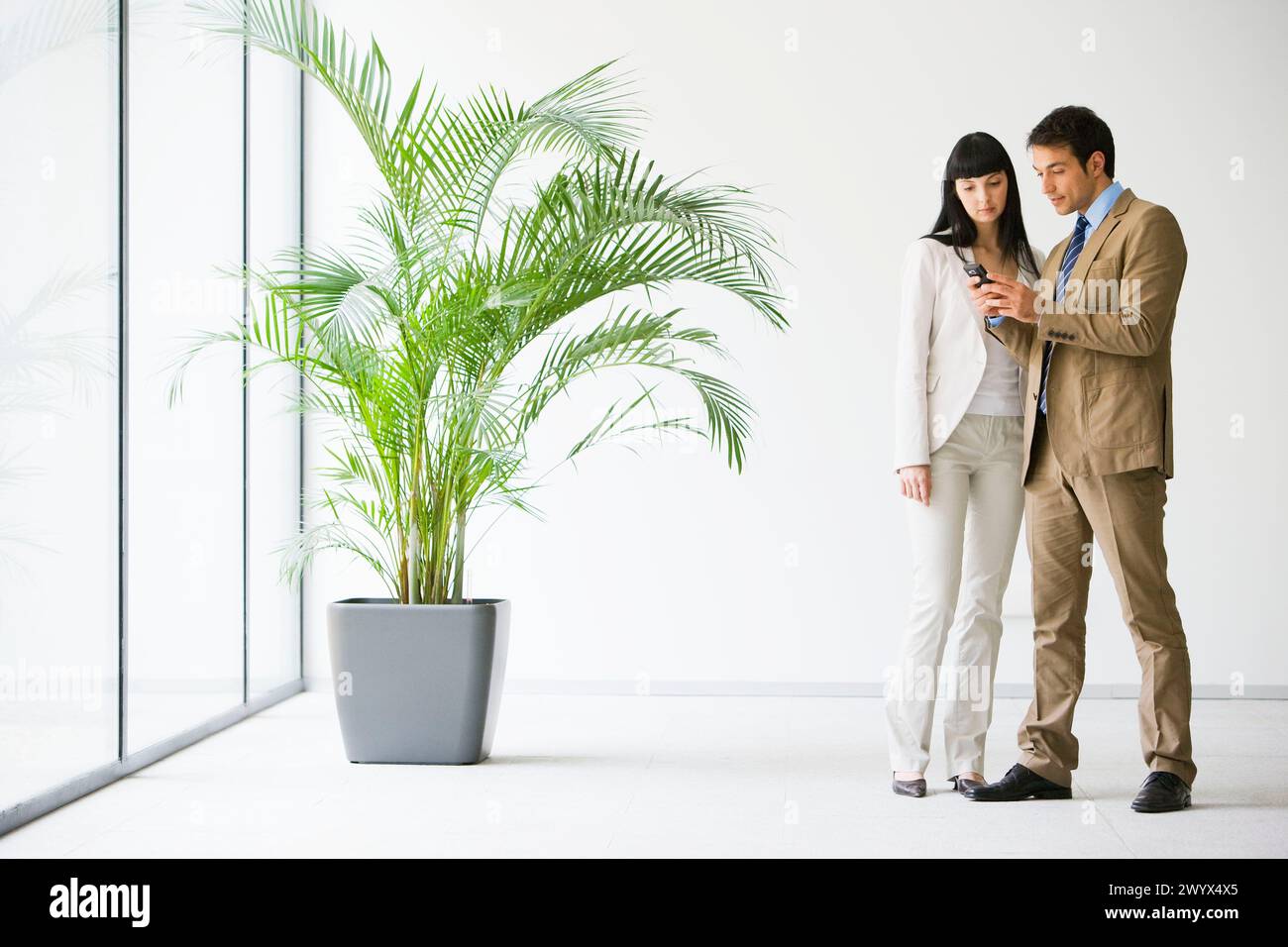 Two businessmen stand using hi-res stock photography and images - Alamy