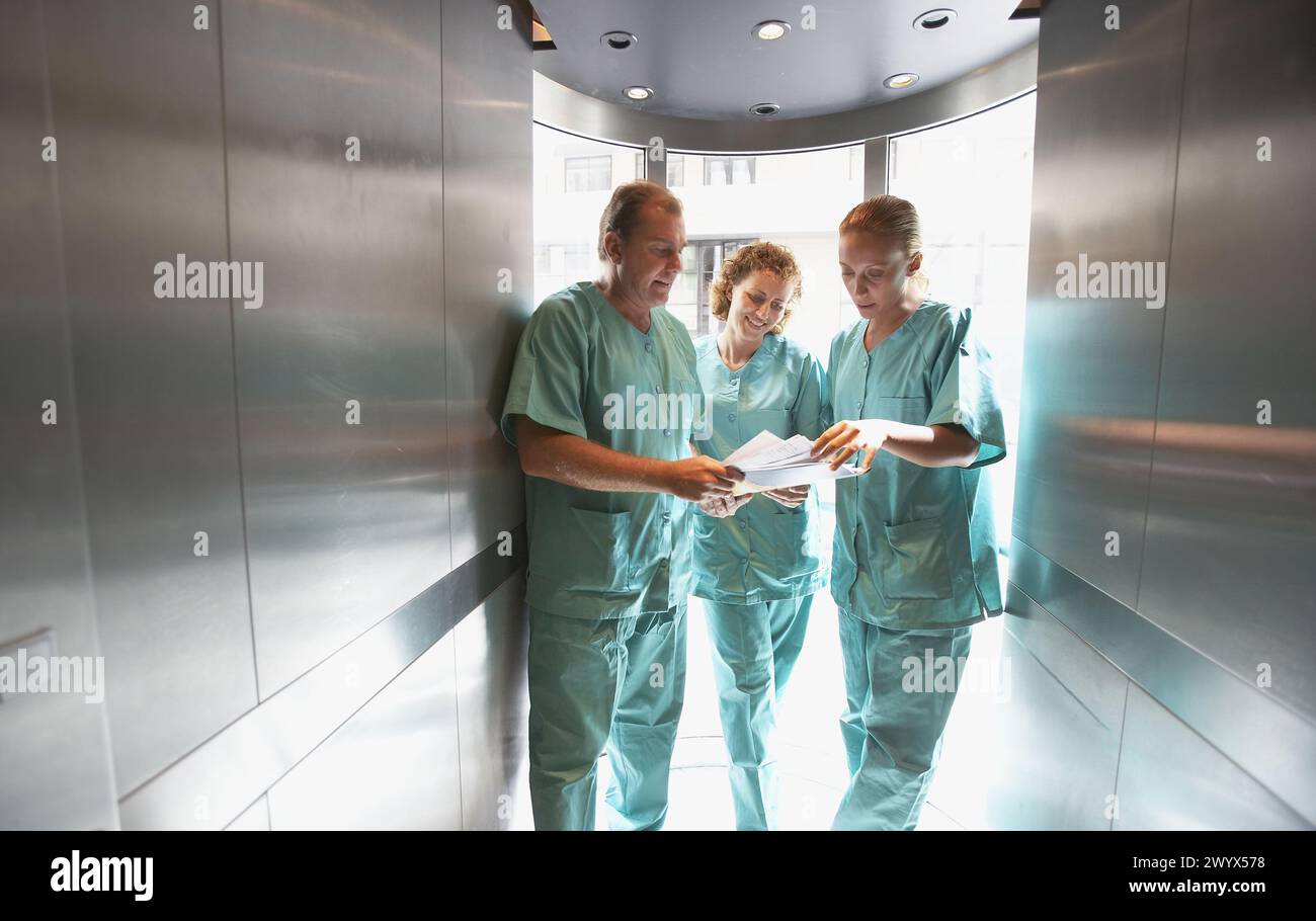 Doctors in lift Stock Photo - Alamy