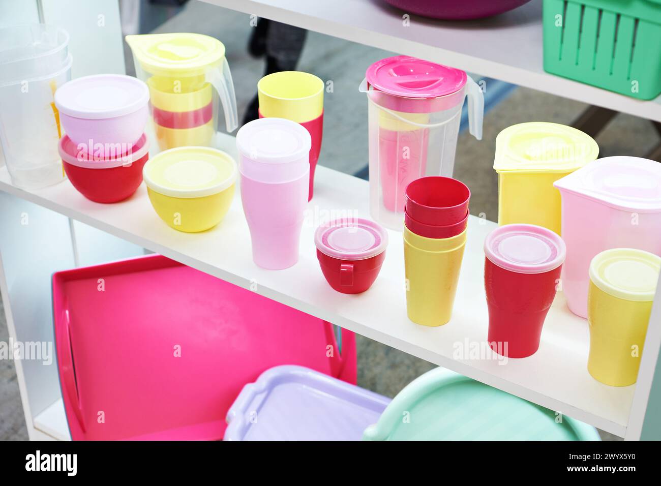 Colorful plastic cups and dishes in the store Stock Photo - Alamy