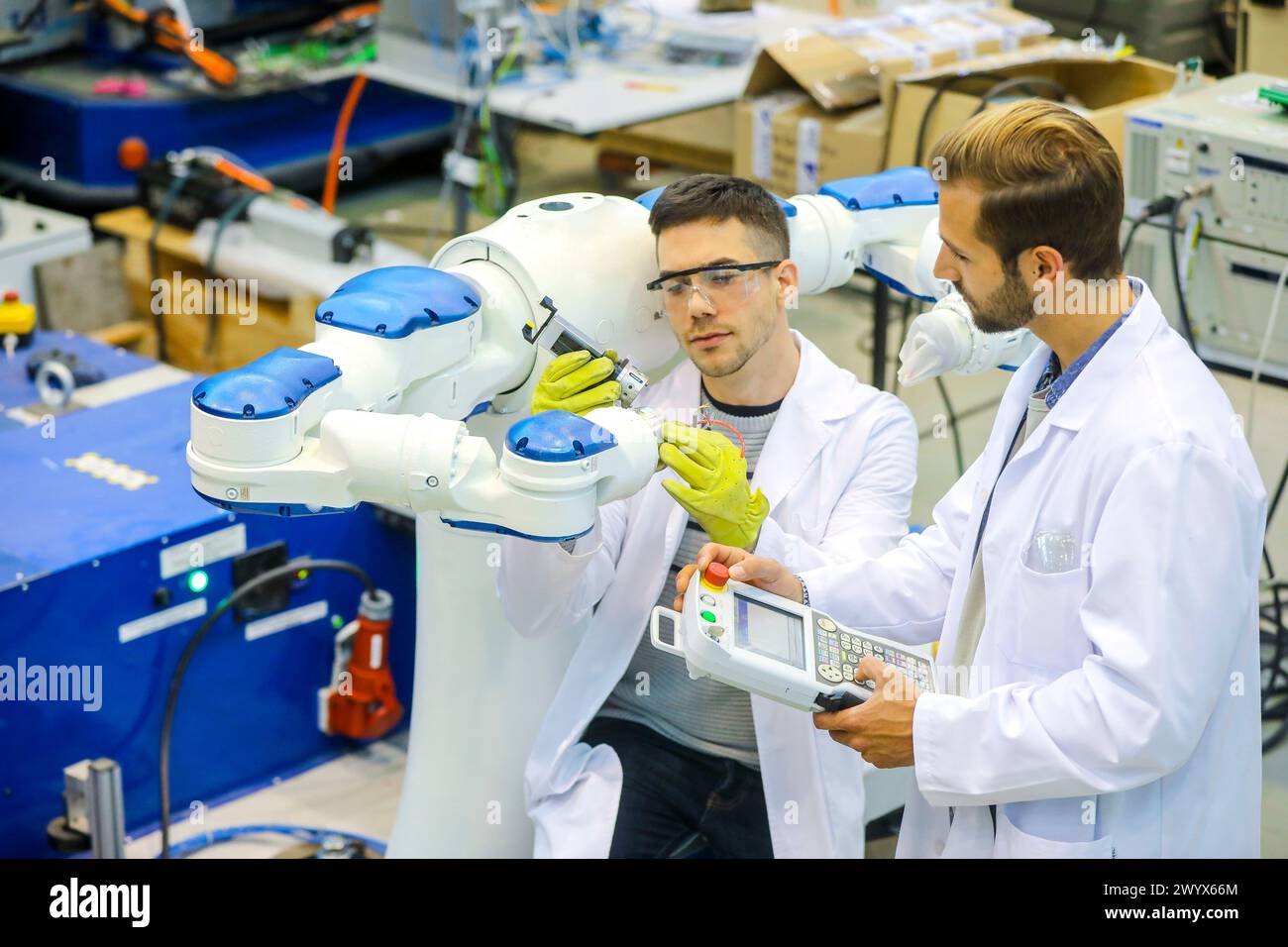 Two-arm robot for industrial handling. Researchers working on robot ...