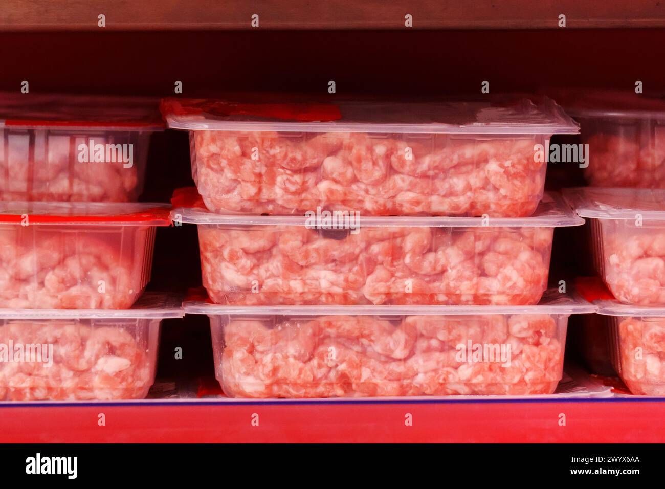 Plastic containers filled with various cuts of meat, ready for ...