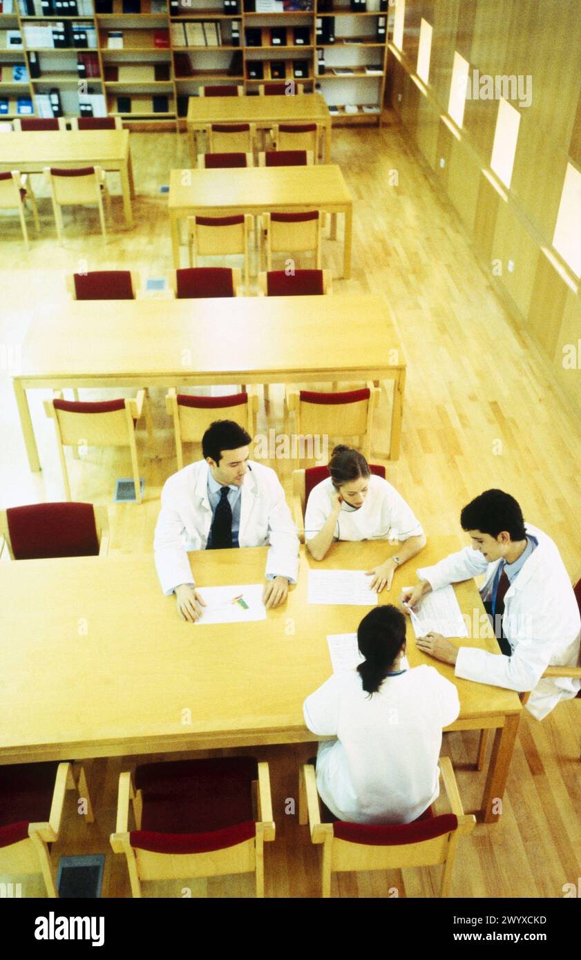 Meeting of doctors at library of hospital Stock Photo - Alamy
