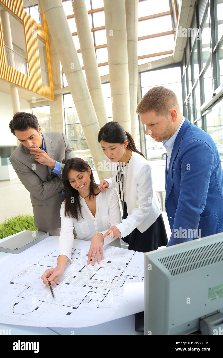 Architects looking at blueprints Stock Photo - Alamy