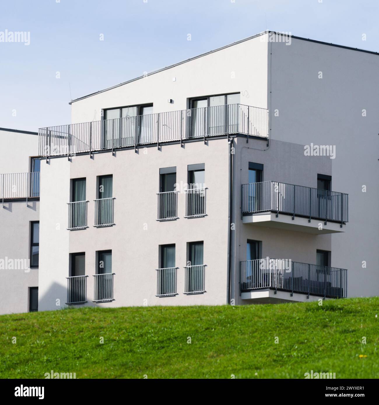 Newly built block of flats in nature. Modern, ecological, generic ...