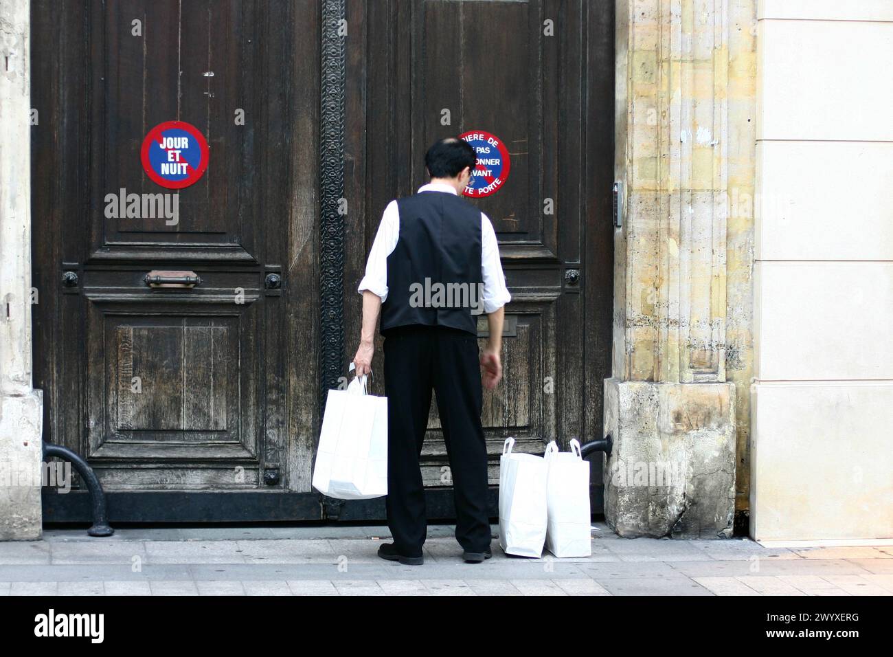 Man at a building door delivers ordered food for the dinner at the ...