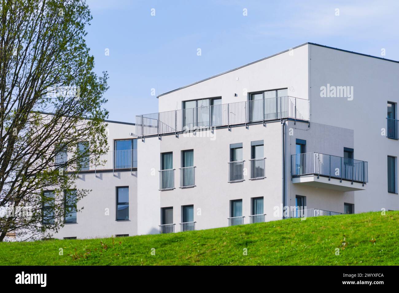 Newly built block of flats in nature. Modern, ecological, generic ...
