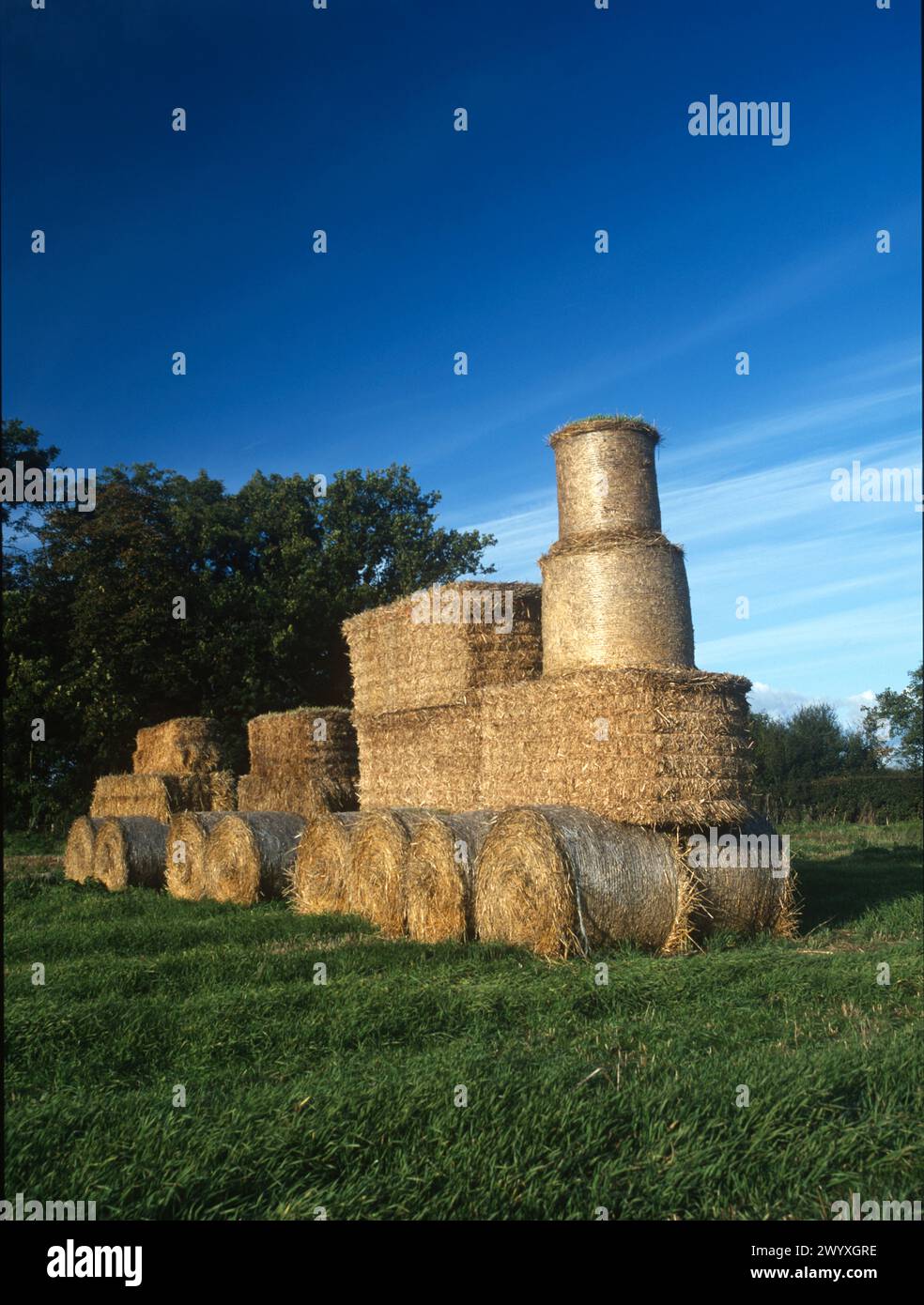 Steam train sculpture made from hay bales in field at the side of the ...