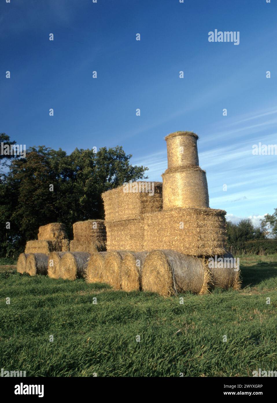 Steam train sculpture made from hay bales in field at the side of the ...
