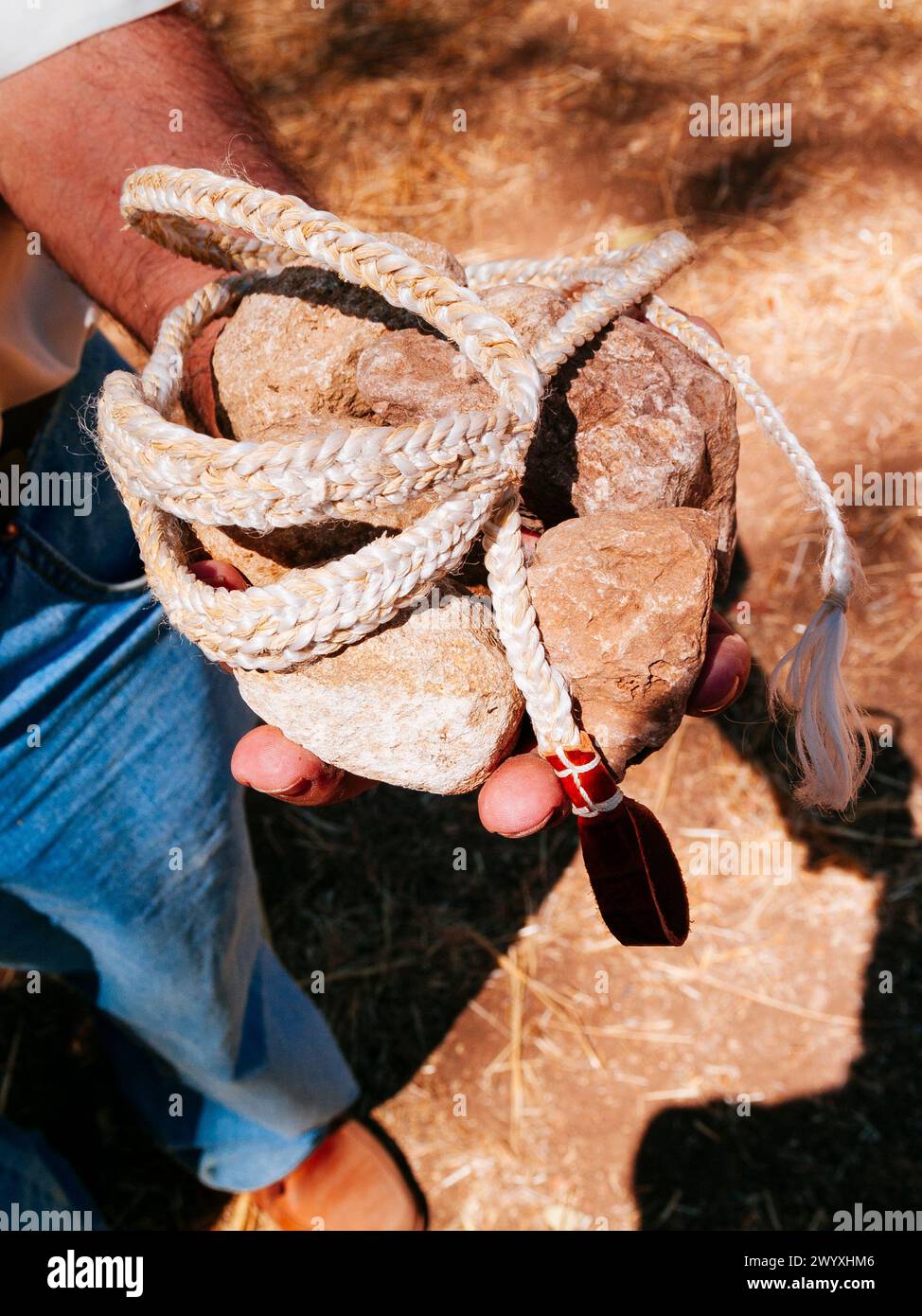 Close up. Shepherds sling demonstration. A sling is a projectile weapon ...