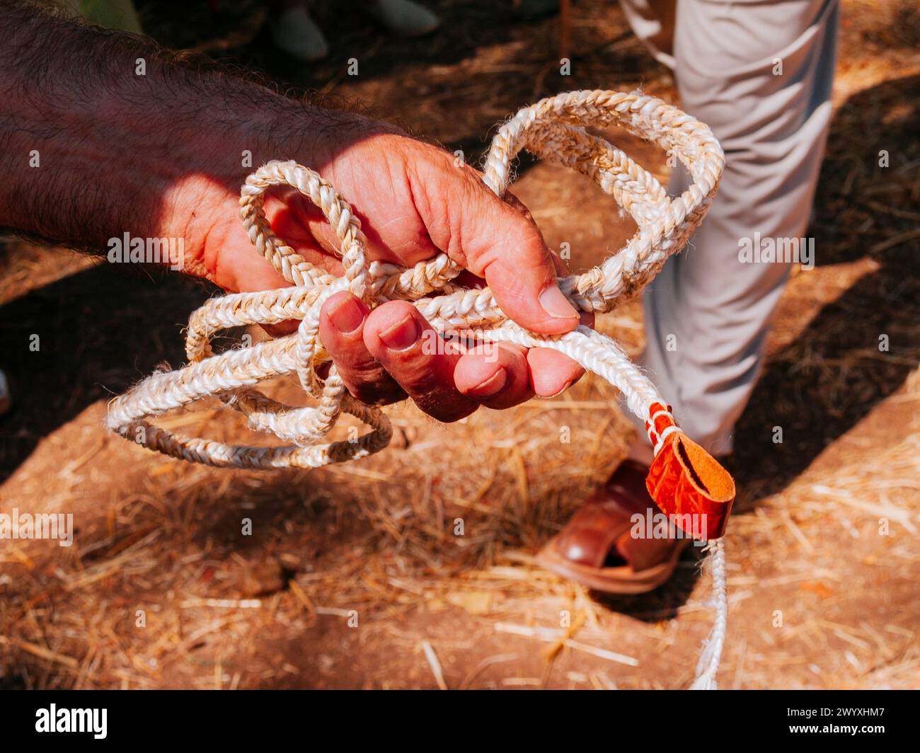 Close up. Shepherds sling demonstration. A sling is a projectile weapon ...