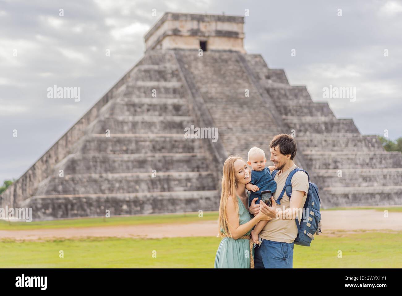 mother, father and and their son baby observing the old pyramid and ...