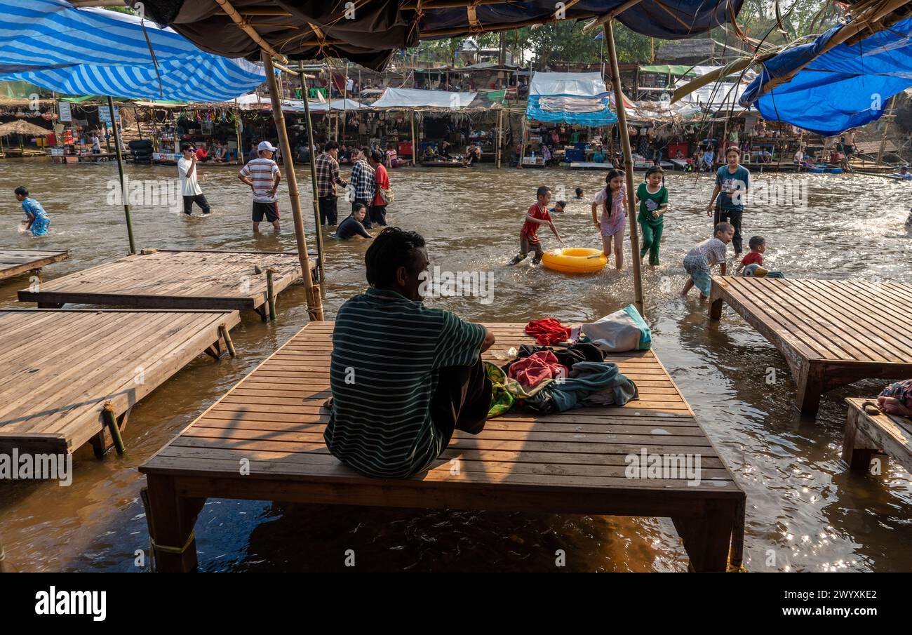 Thai and Burmese families swimming and playing in the Thailand ...