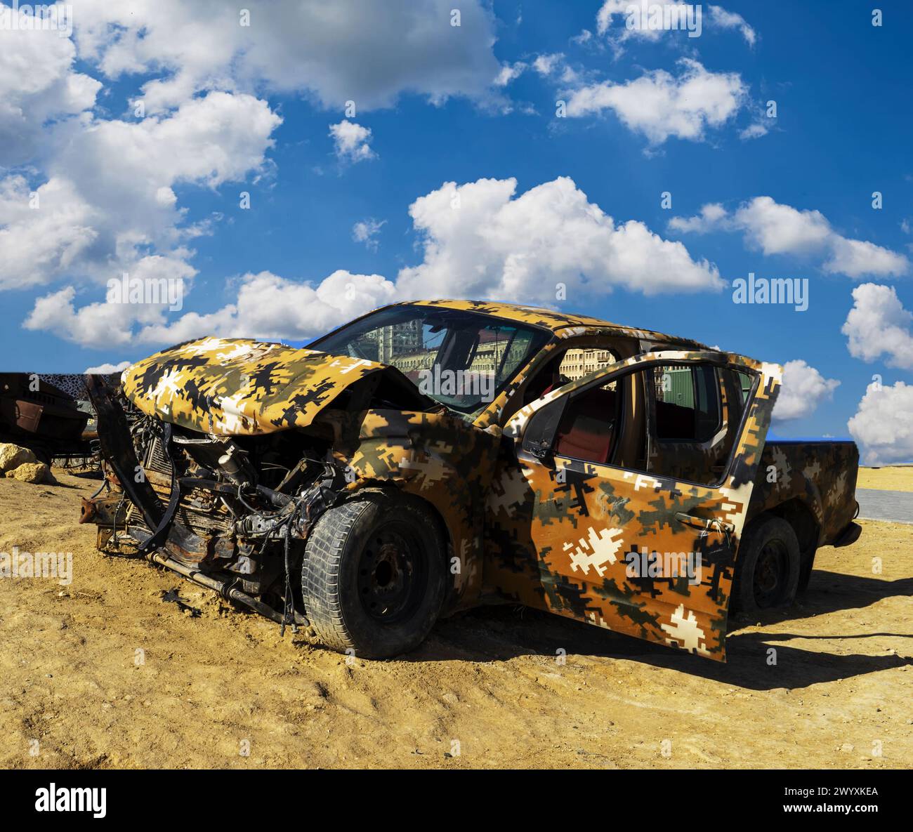 A damaged military armored vehicle, a passenger car , a jeep and ...