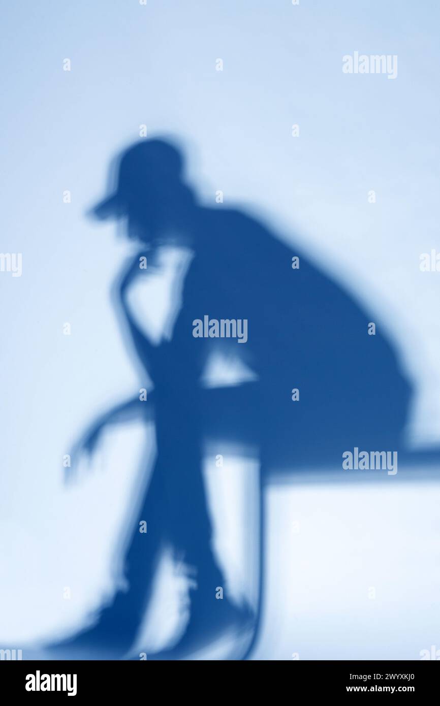 Shadow, young man sitting Stock Photo - Alamy