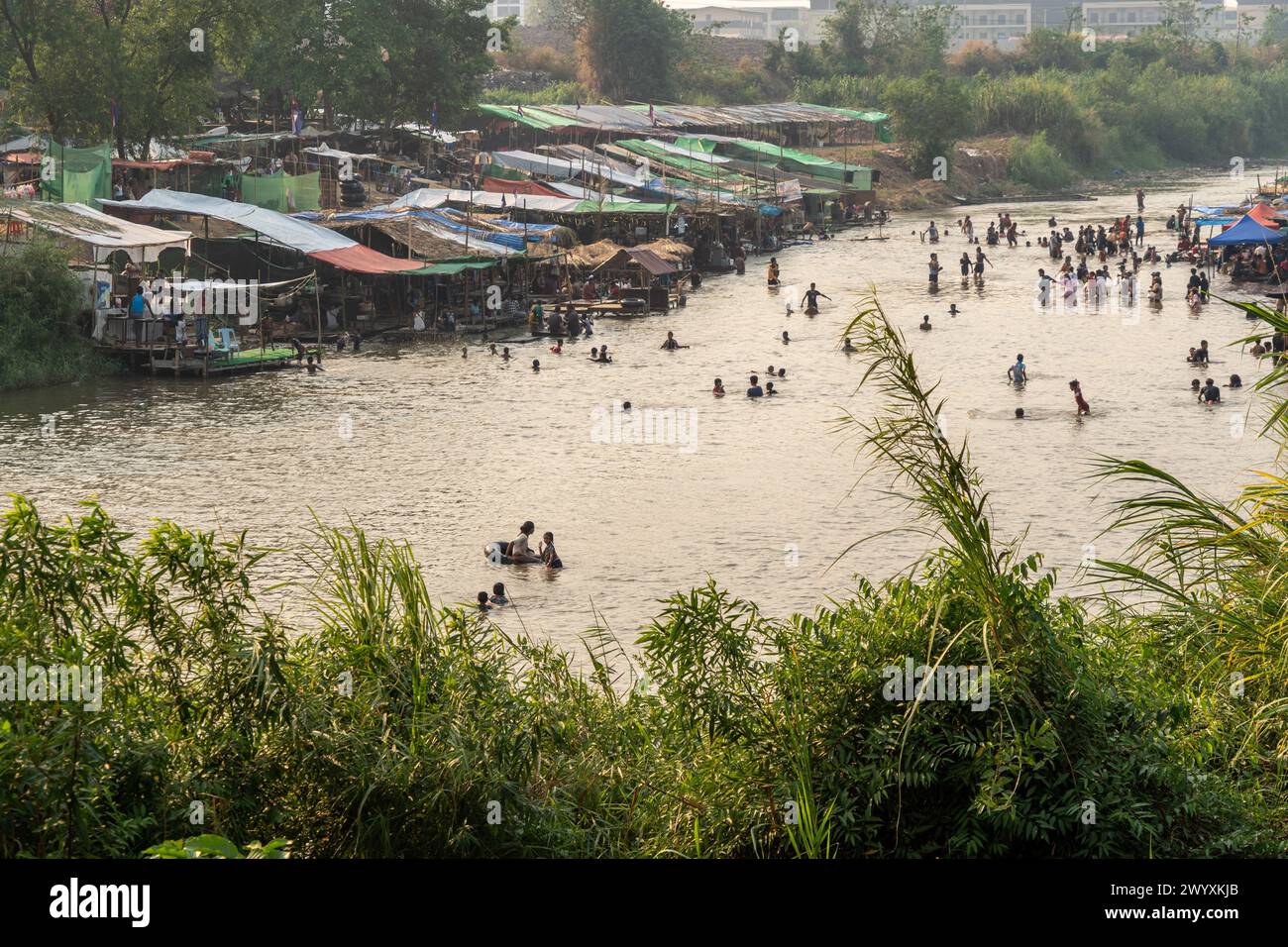 Thai and Burmese families swimming and playing in the Thailand ...