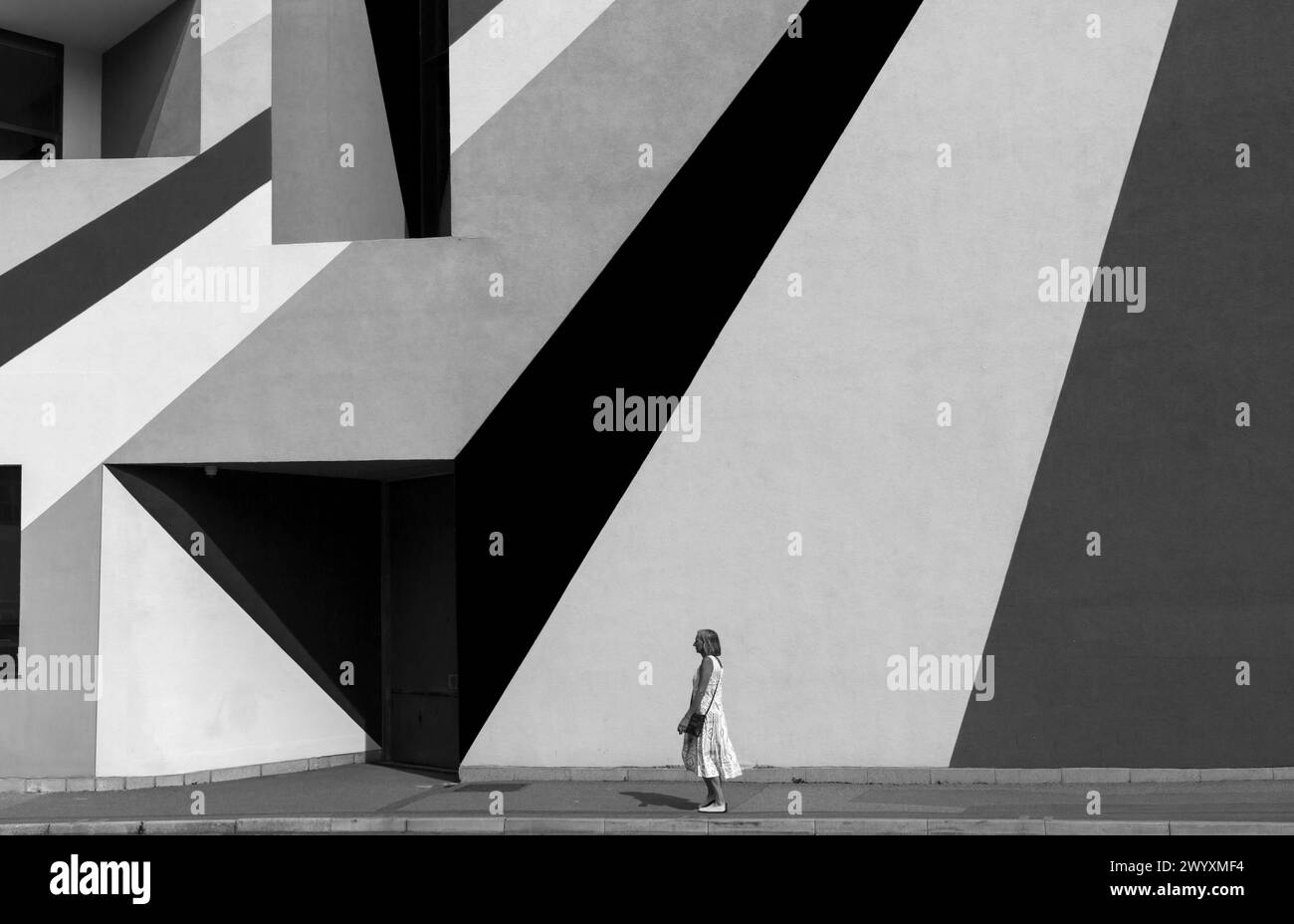 Woman walks past the Towner Art Gallery with colourful Dance Diagonal artwork by German artist ...