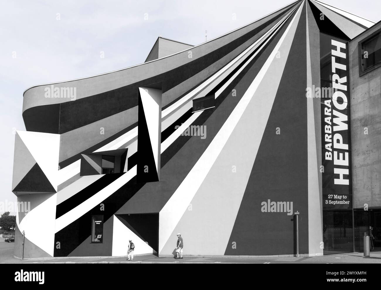 people walk past the Towner Art Gallery with colourful Dance Diagonal artwork by German artist ...