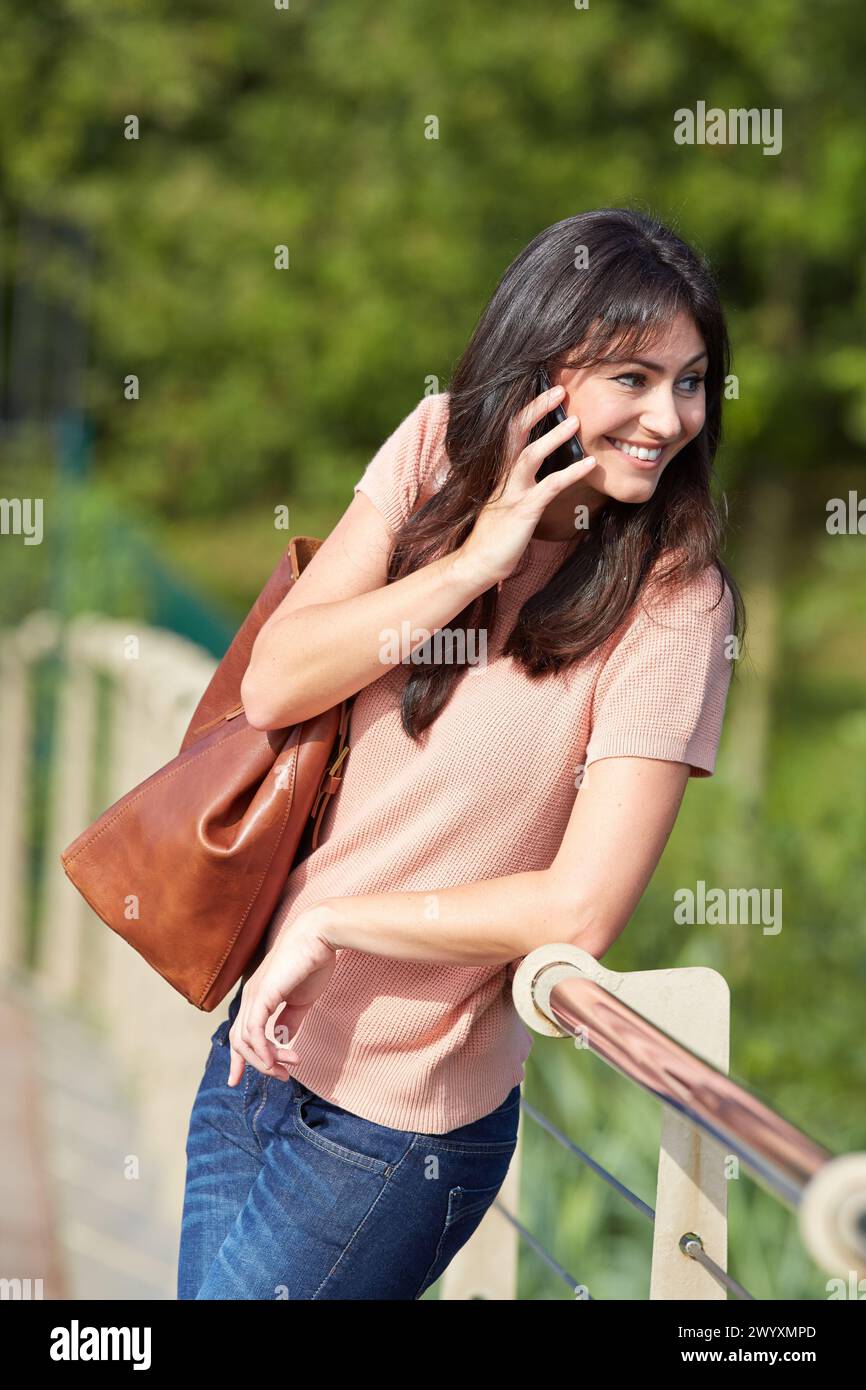 35 year old Woman in park talking with smartphone. Donostia. San ...