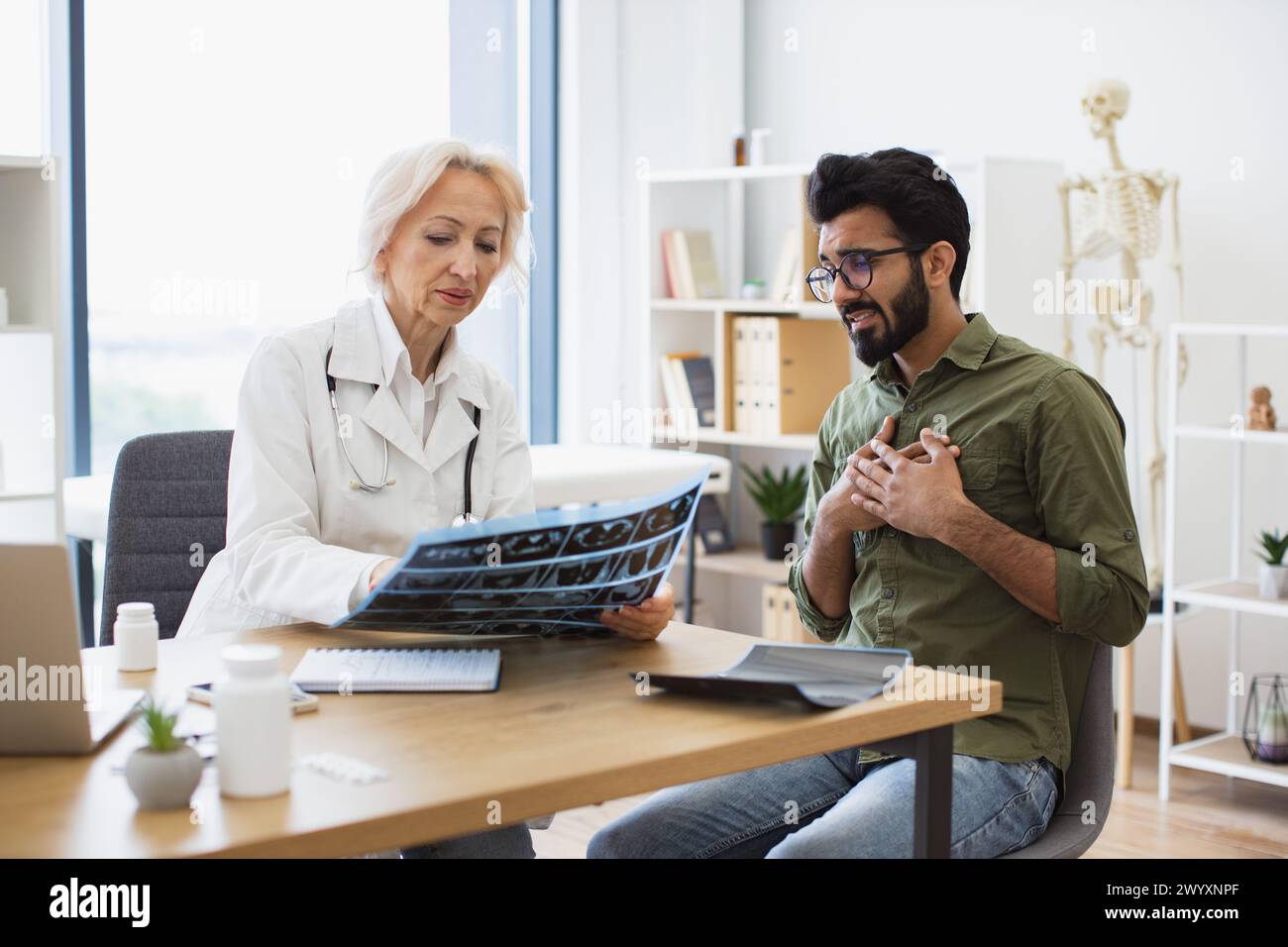 Family doctor examining diagnostic test results while developing ...