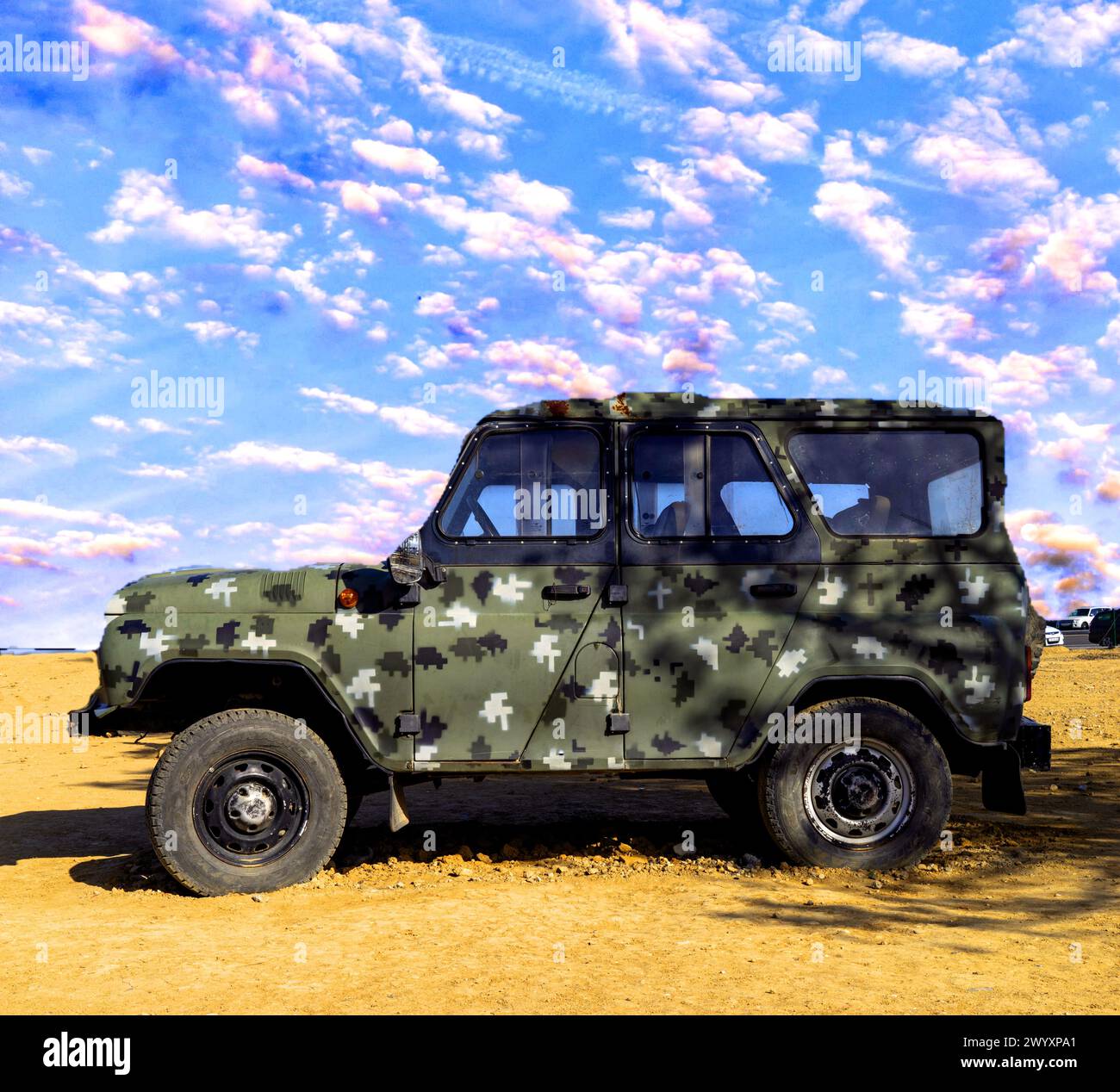 A damaged military armored vehicle, a passenger car , a jeep and ...