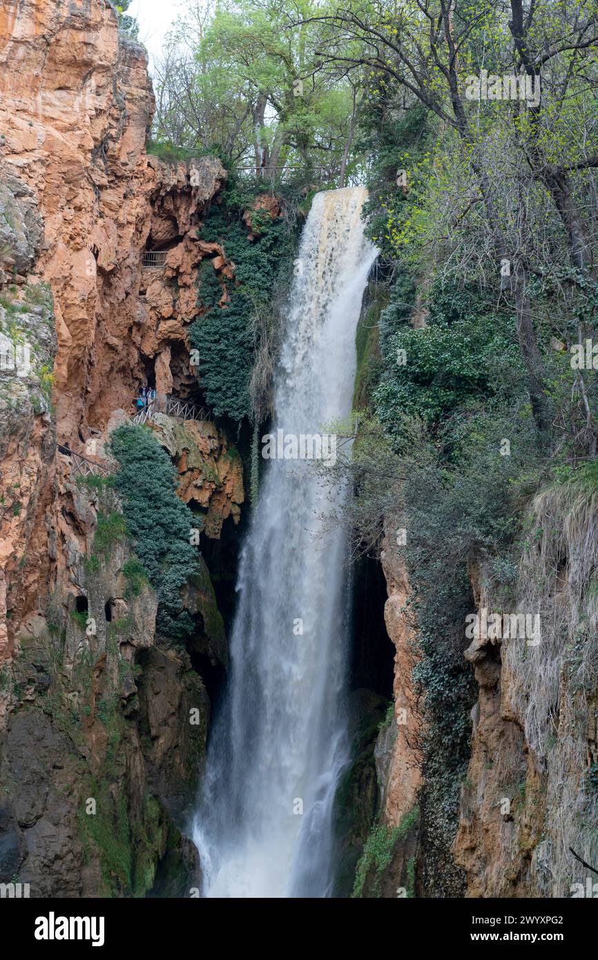 Lush greenery frames the powerful cascade at Monasterio de Piedra, a ...