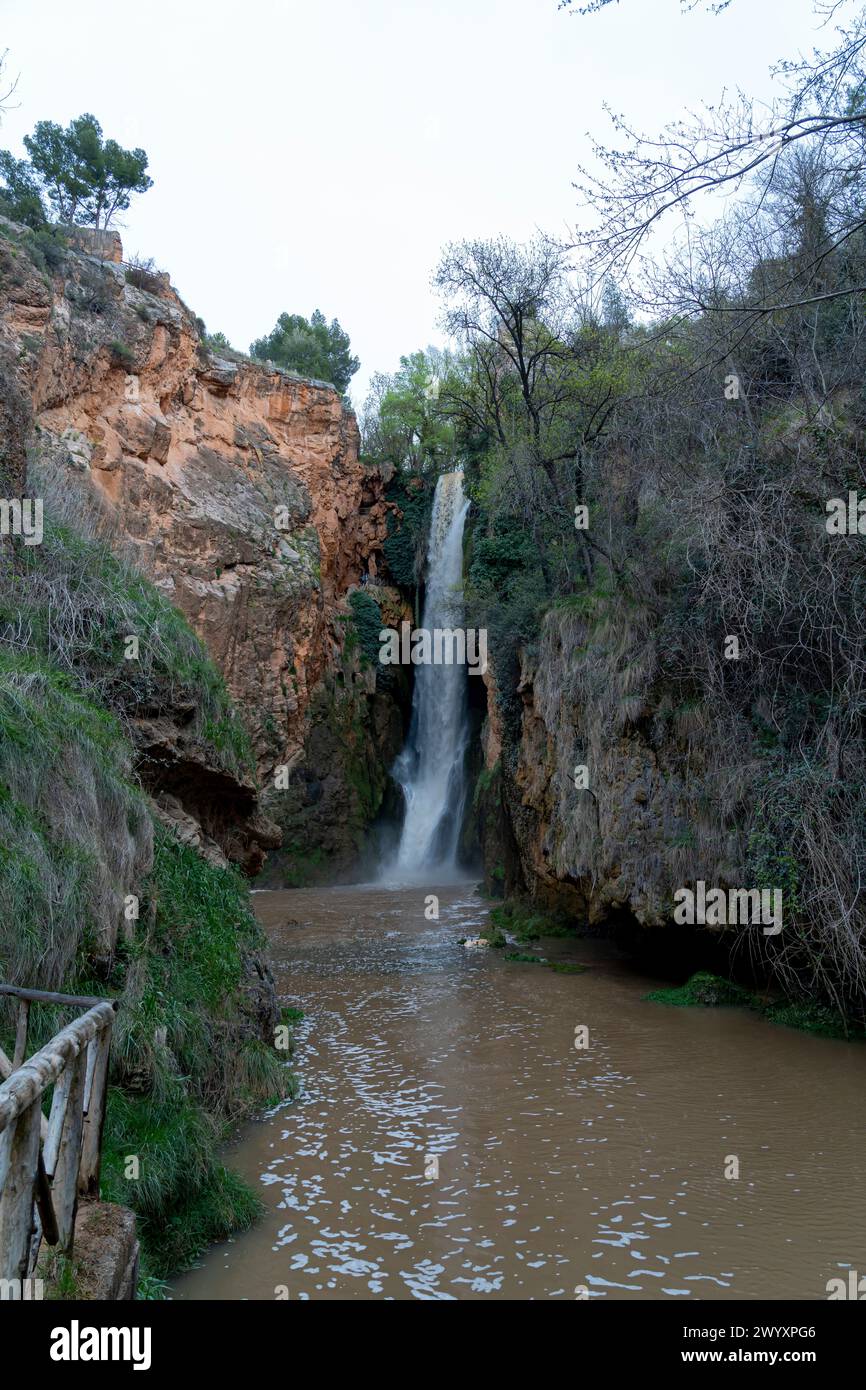 Lush greenery frames the powerful cascade at Monasterio de Piedra, a ...